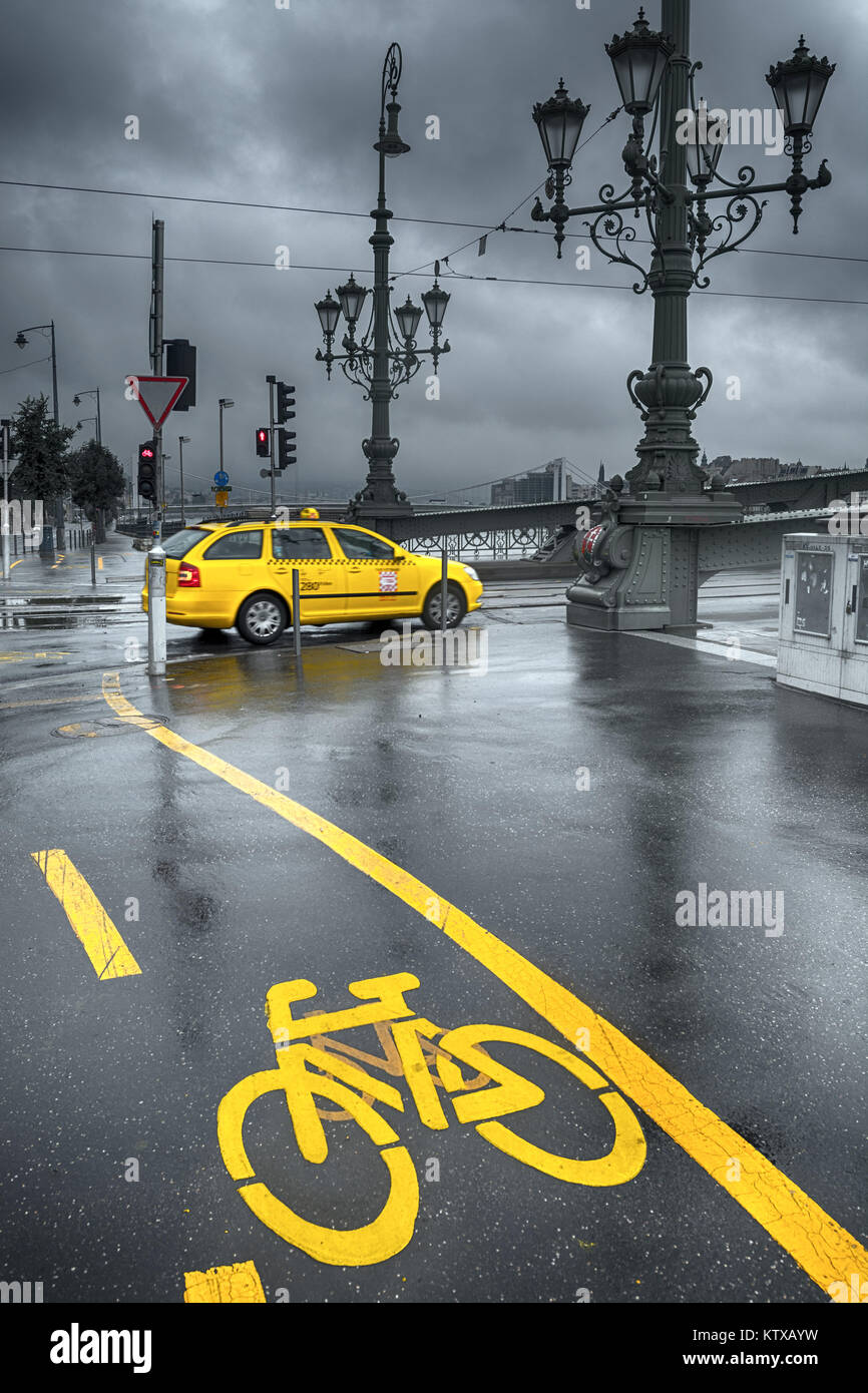 Yellow road marking and car against gray city environment Stock Photo ...