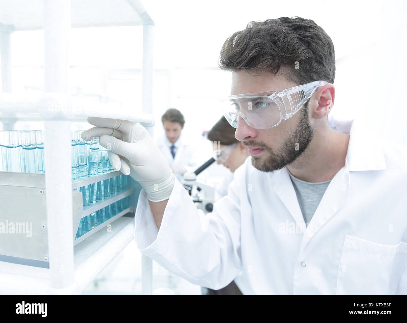 A young man doing an experiment in a chemical laboratory Stock Photo ...