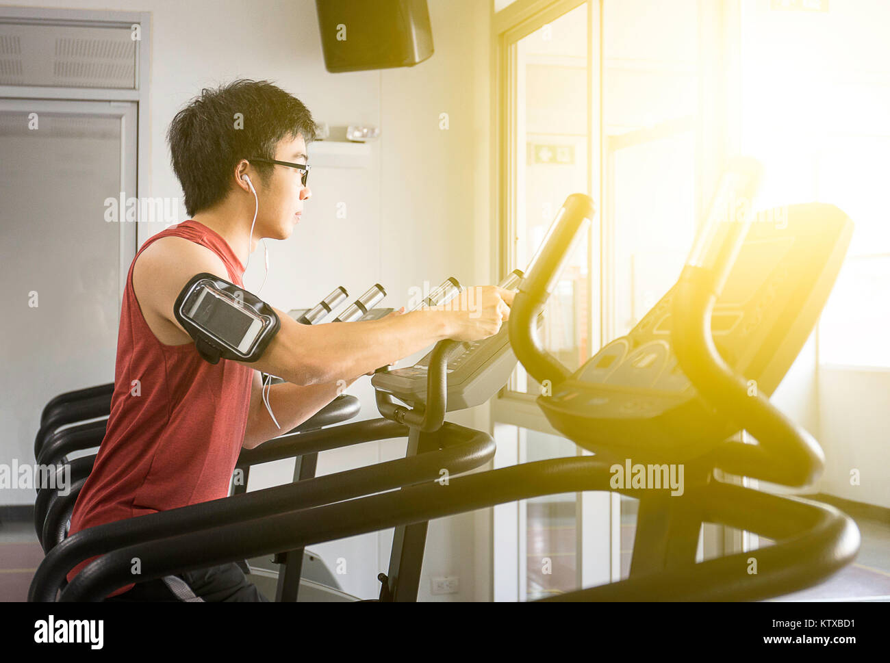 handsome man on running machine with listen music for relax in gym ...