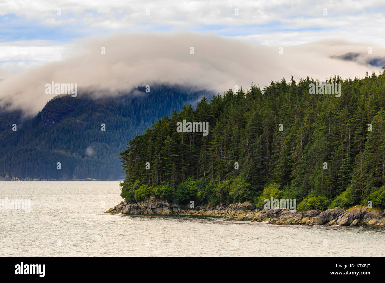 Mist, rocky shoreline and forest, Inian Islands, Icy Strait, between ...