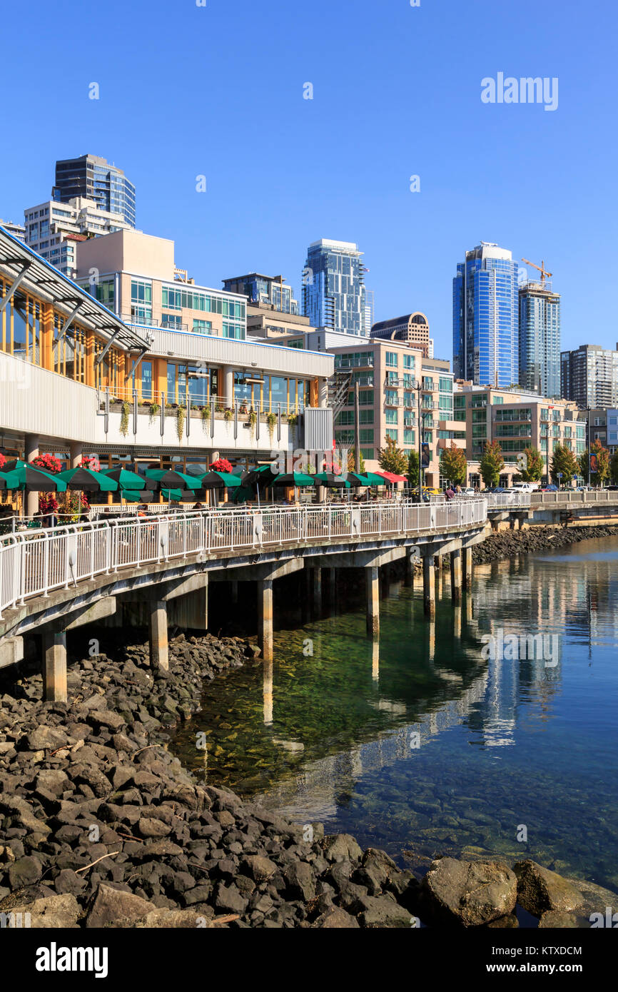 Seattle skyline and restaurants on sunny day in Bell Harbor Marina ...
