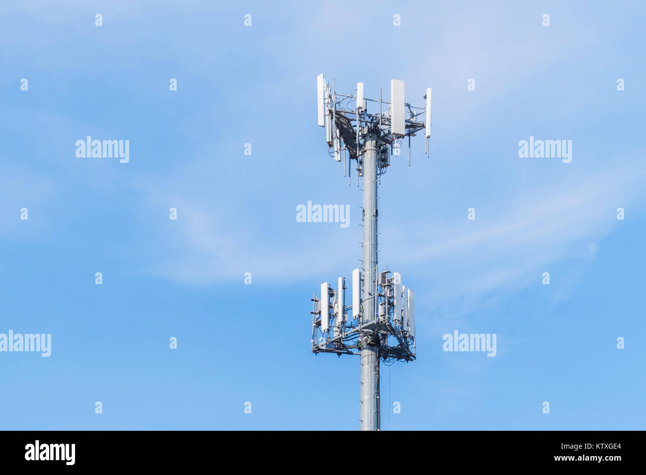 A wireless cell tower against a blue sky. USA Stock Photo - Alamy