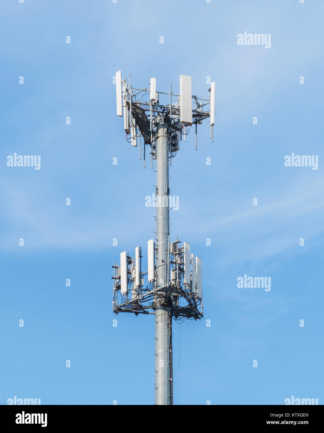 A wireless cell tower against a blue sky. USA Stock Photo - Alamy