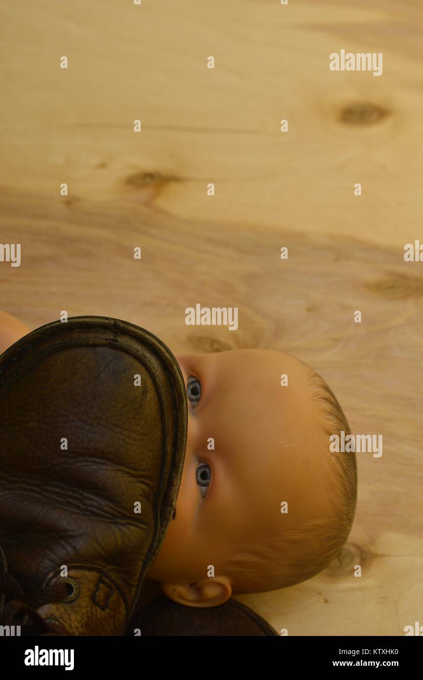 Shoes stepping on a toy doll hi-res stock photography and images - Alamy