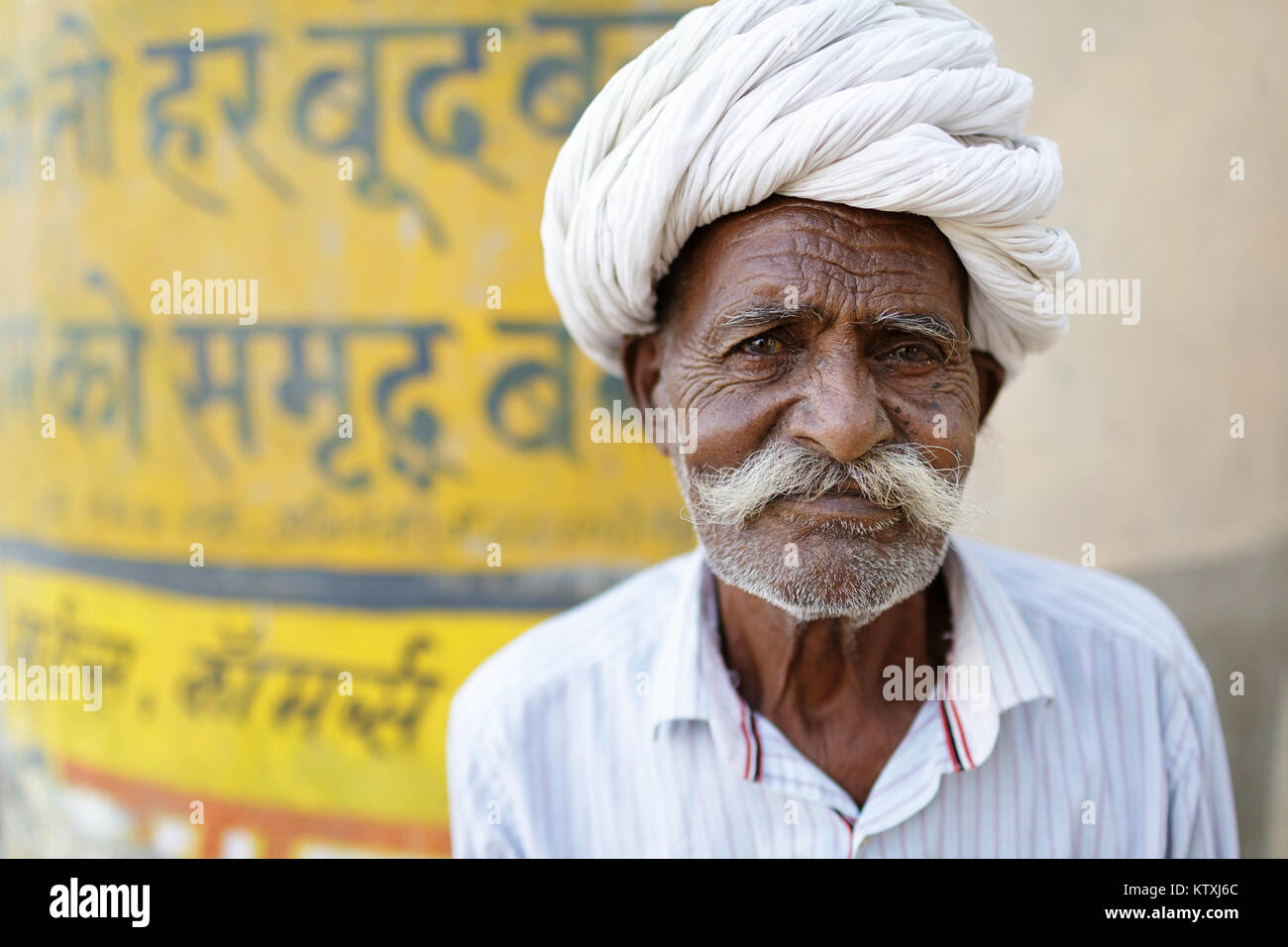 Senior indian man with big mustache in white wearing white turban ...