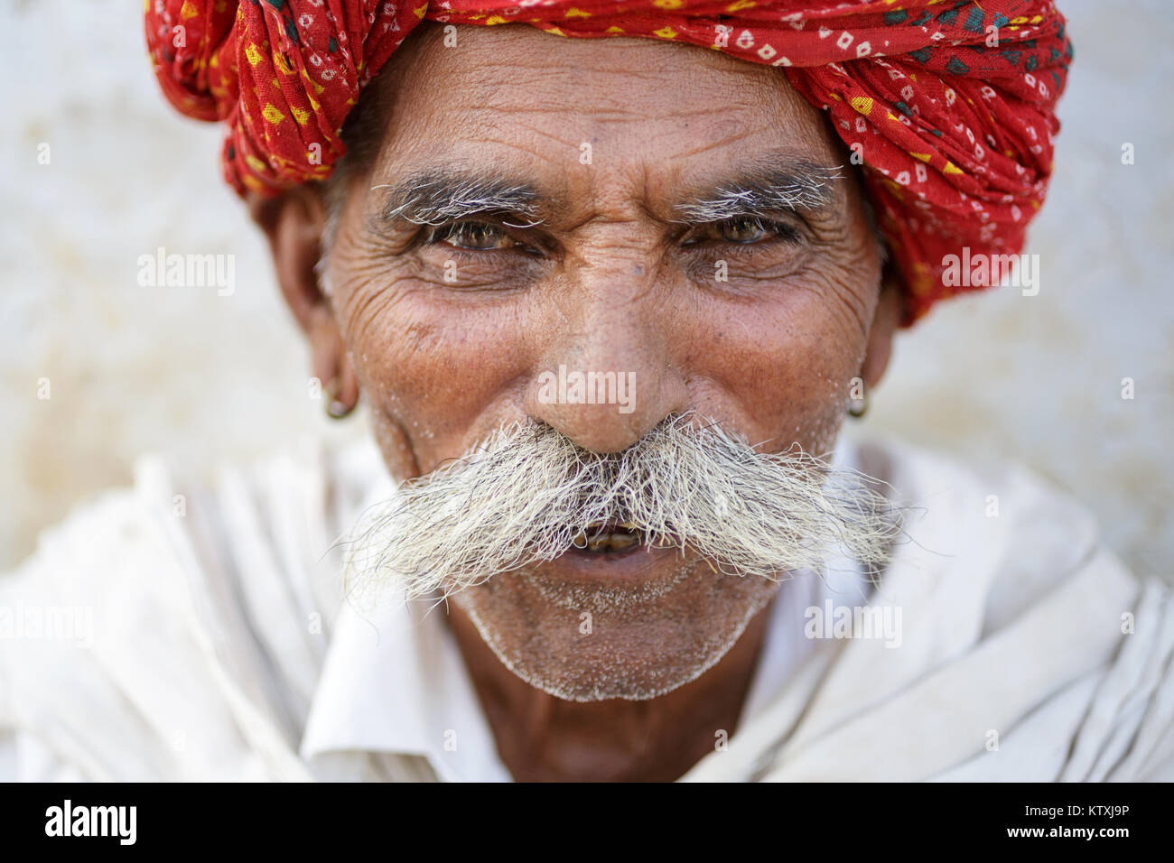 Portrait of senior Indian man in white outfit with big mustache ...