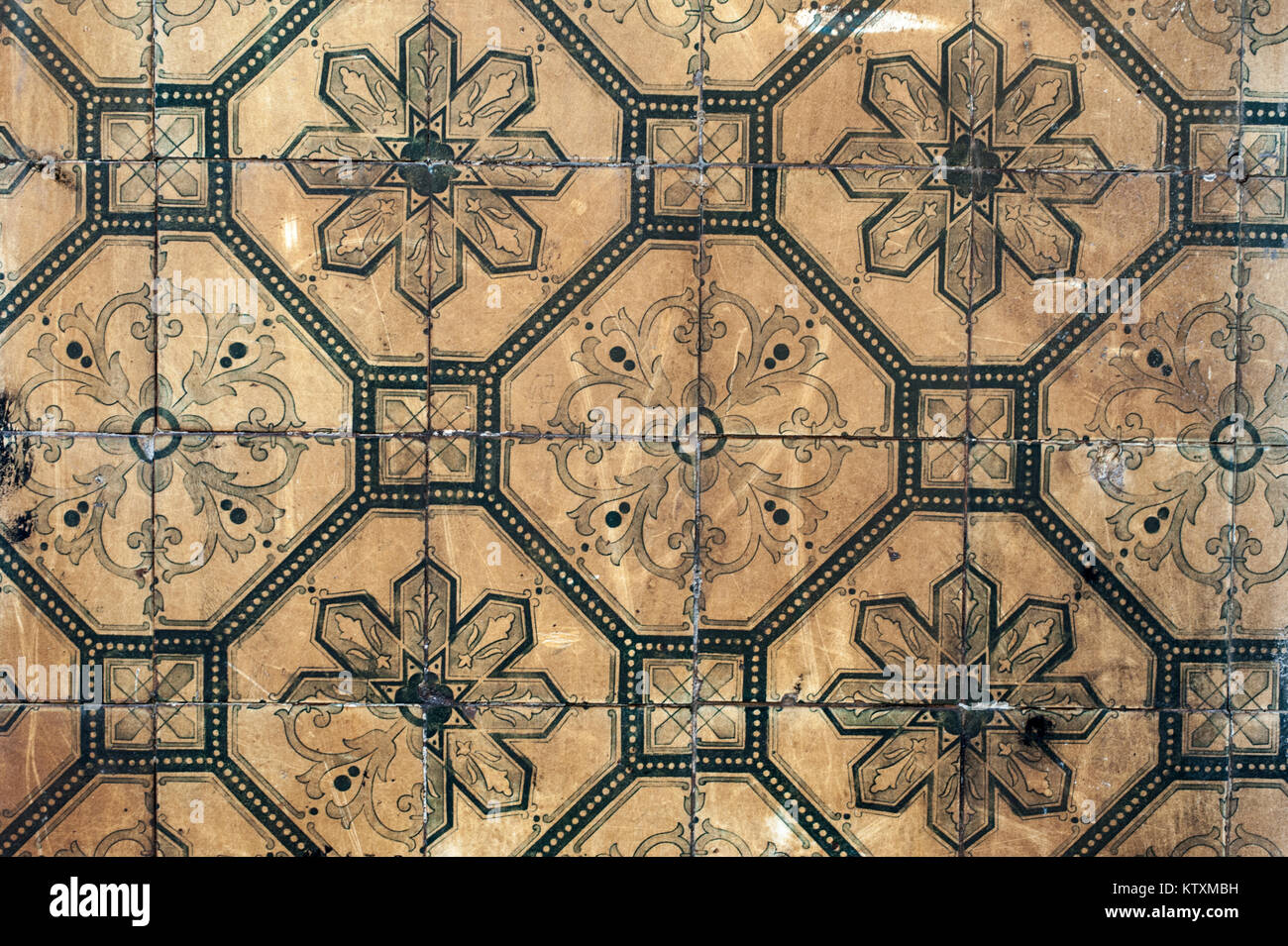 Old, discoloured, Portuguese azulejo ceramic tiles with a floral ...