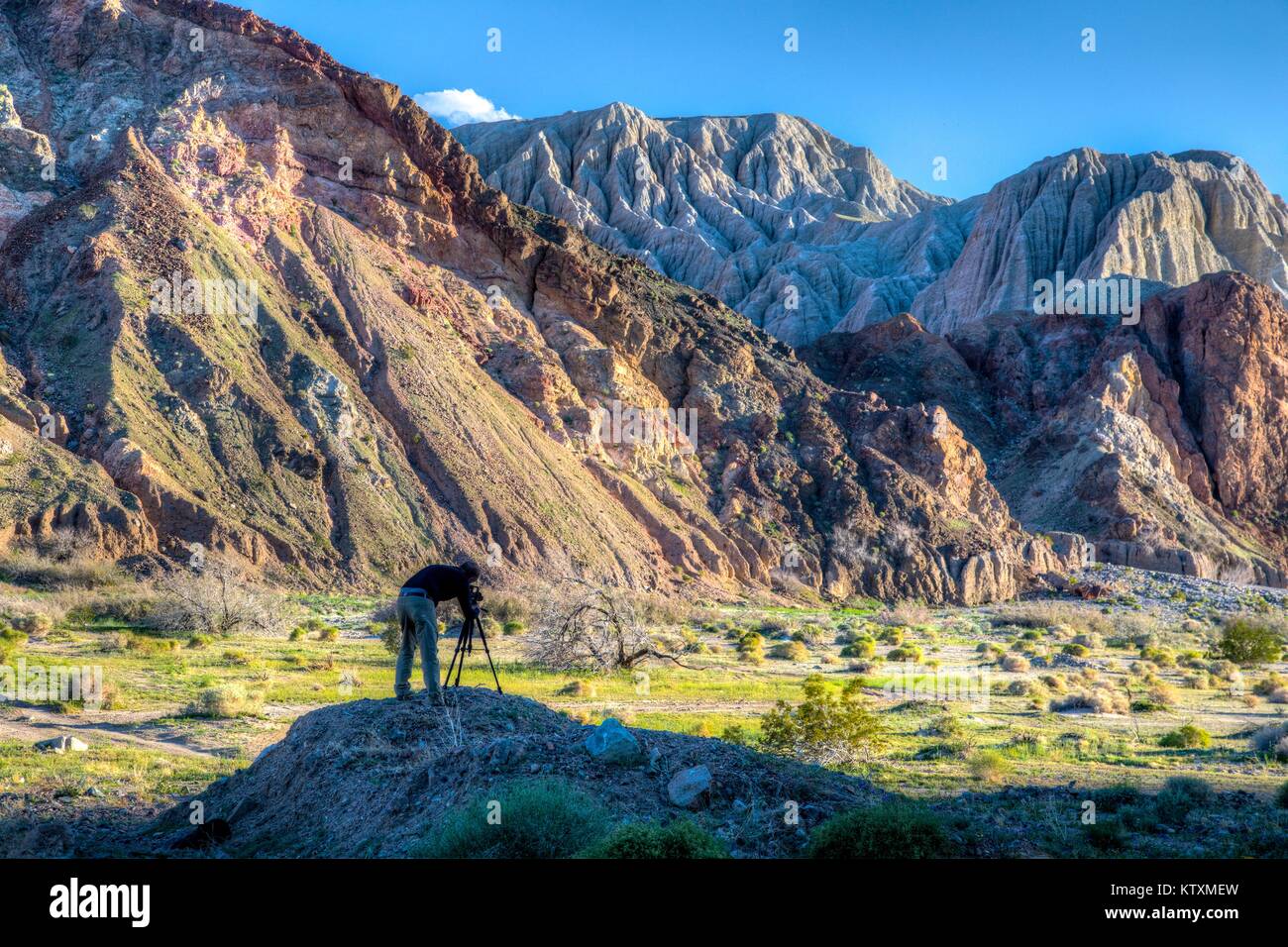 A tourist takes a photo of rock formations at the Old Spanish National ...