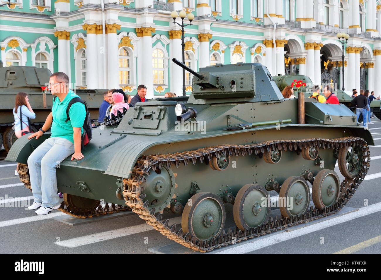 A man sits on the hood of the Soviet small amphibious tank T-38 Stock ...