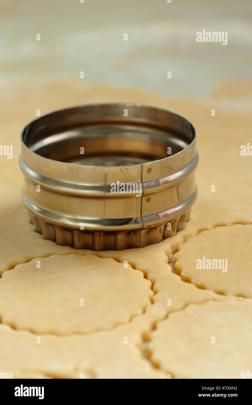 Pastry being cut with a metal cutter Stock Photo - Alamy