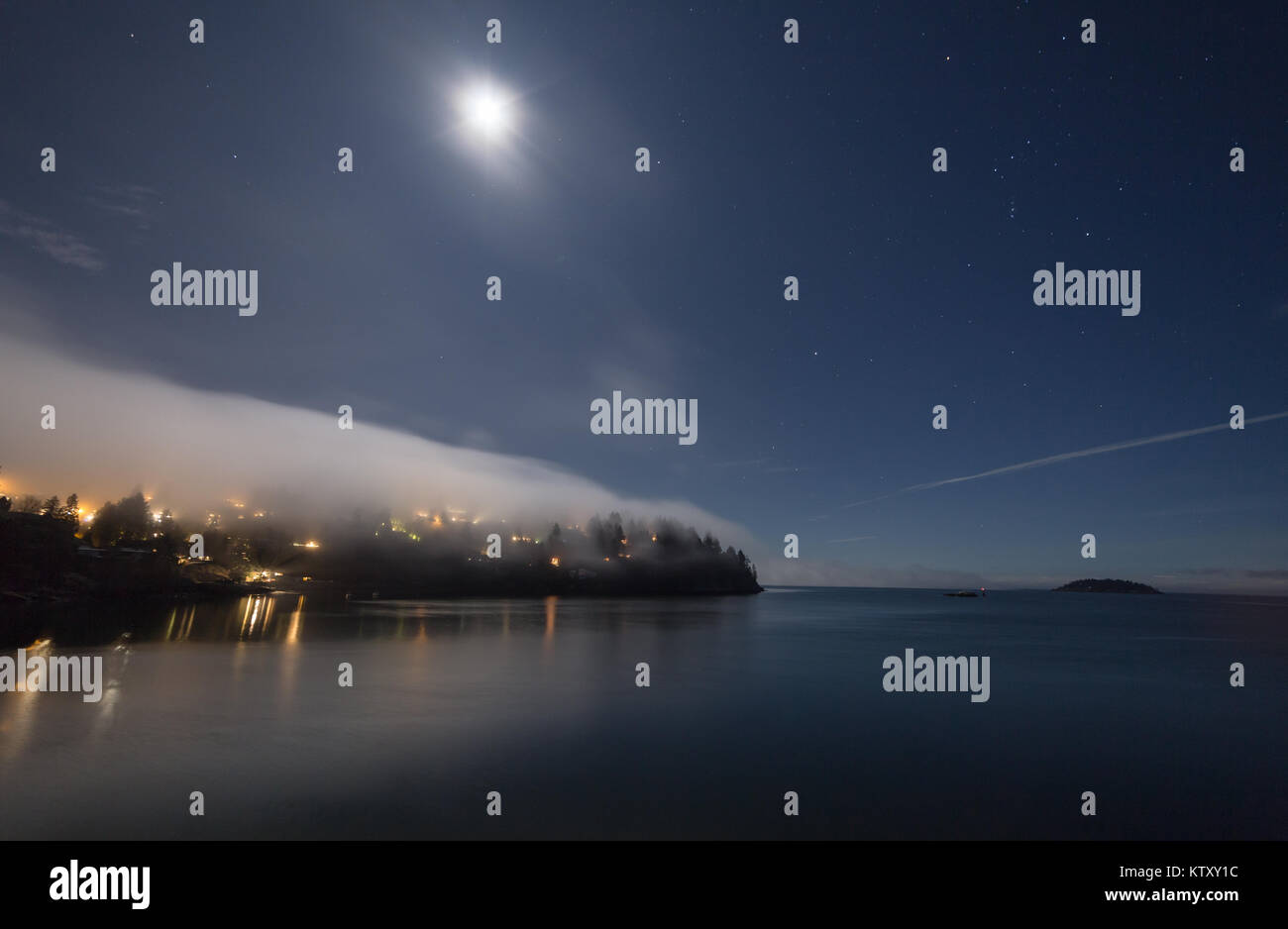 Fog covering the land on a starry night with moon lit Stock Photo - Alamy