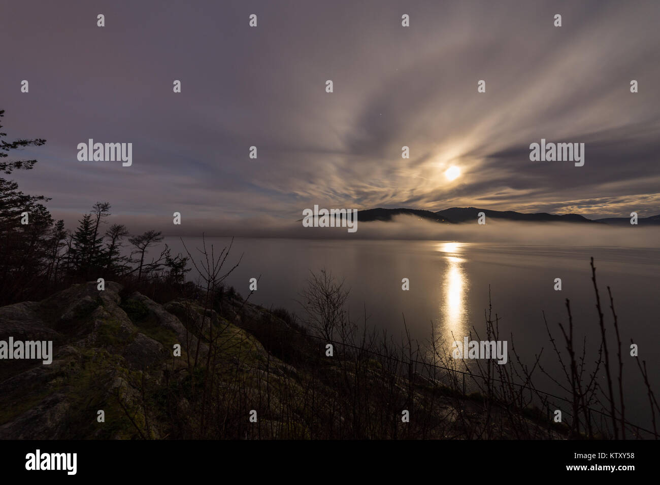 Fog above the ocean on a cloudy night Stock Photo - Alamy