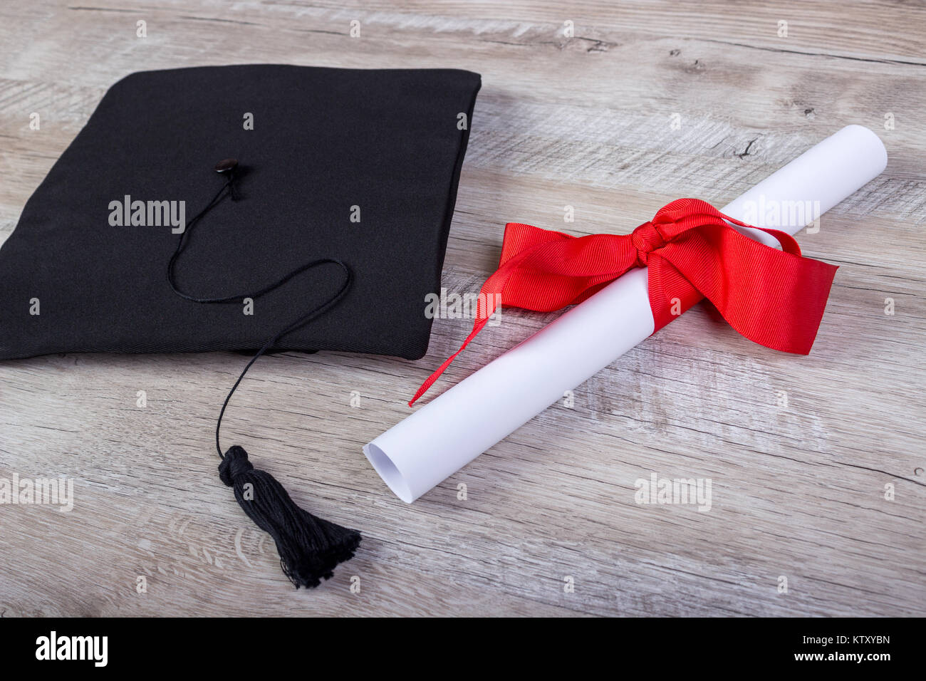 graduation cap, hat with degree paper on wood table graduation concept ...