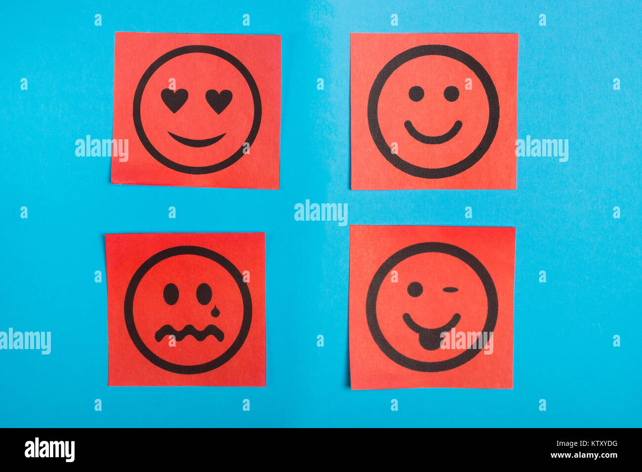 Red paper with faces with emotions on a blue board, message board ...