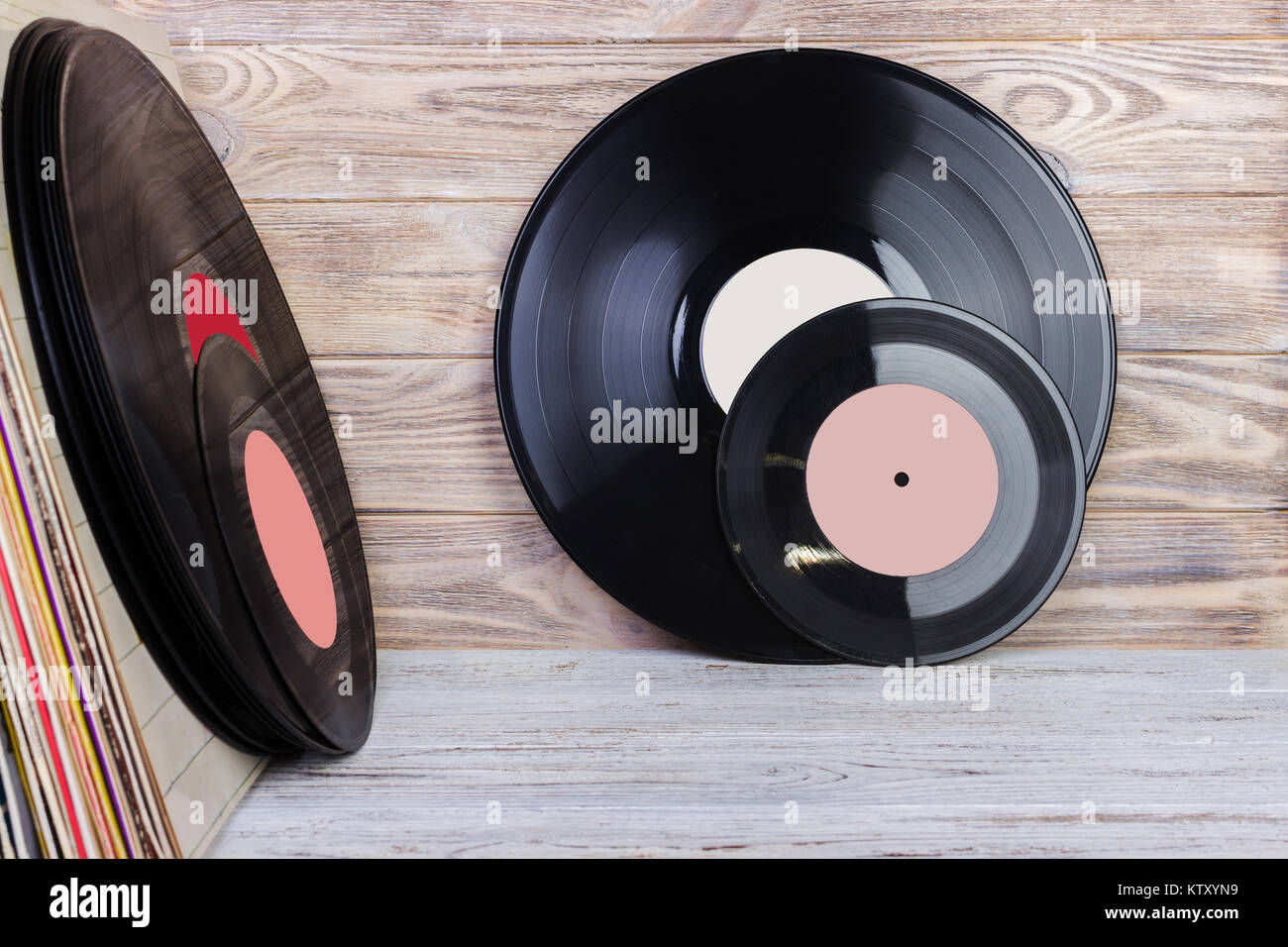 Vinyl record in front of a collection of albums, vintage process. Copy ...