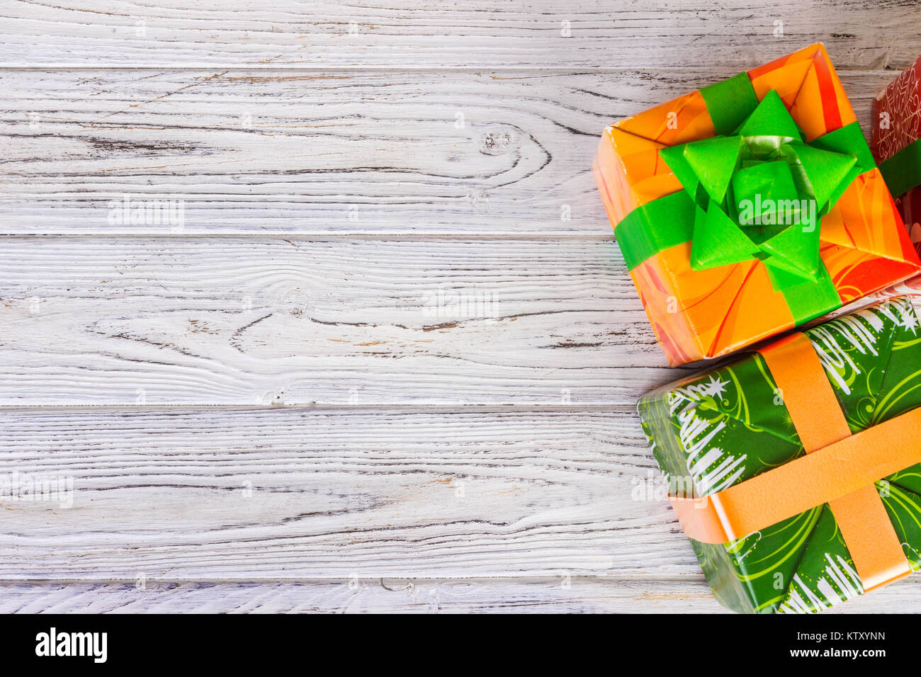 Christmas gift boxes in front of wooden wall. View with copy space ...