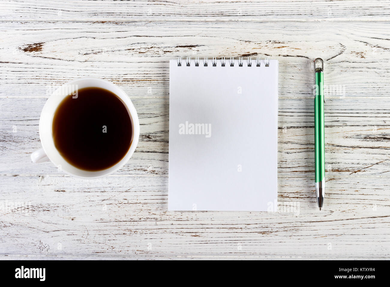 Office table with cup of coffee and notepad Stock Photo - Alamy