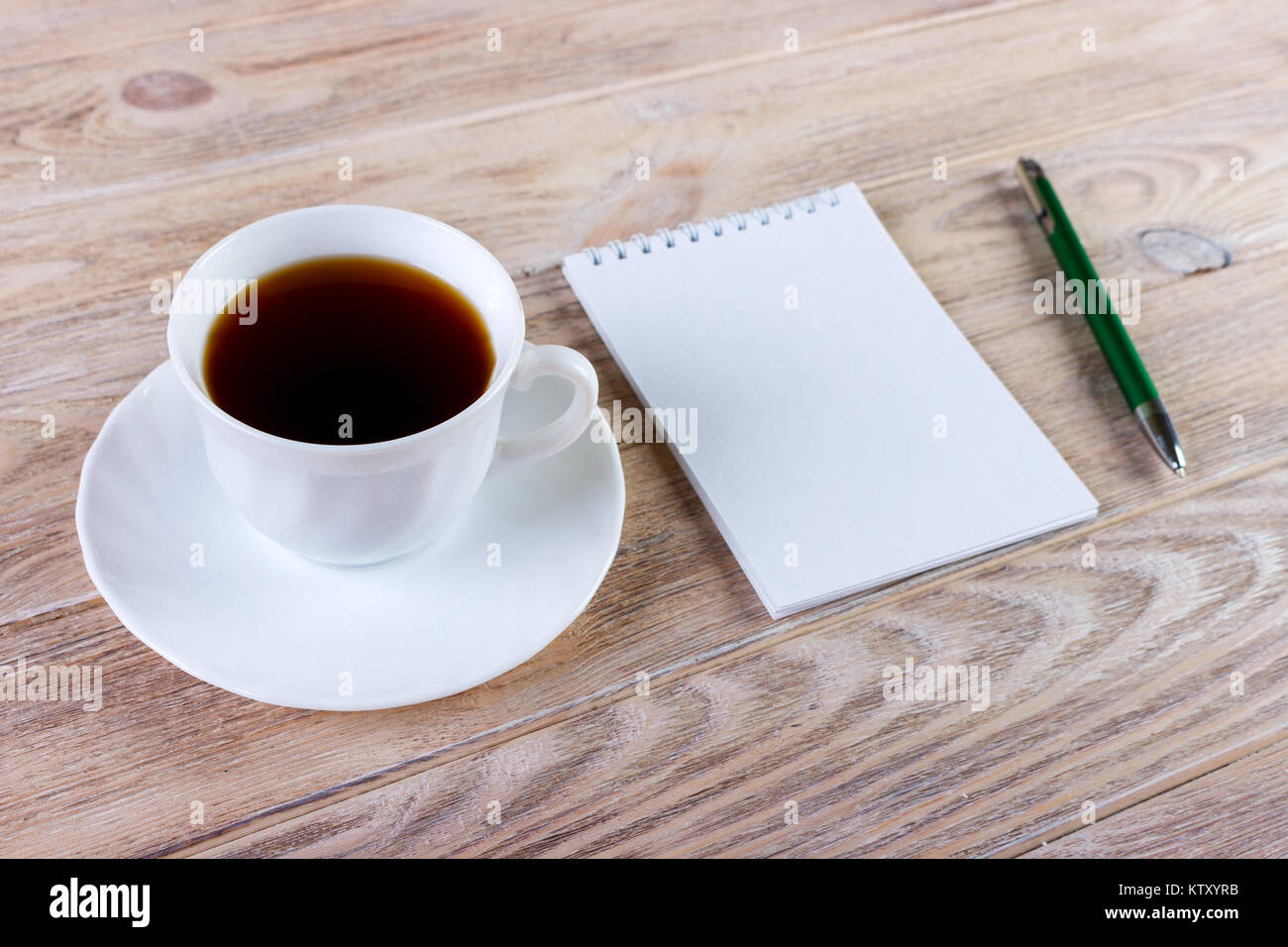 Blank notepad and coffee cup on office wooden table Stock Photo - Alamy