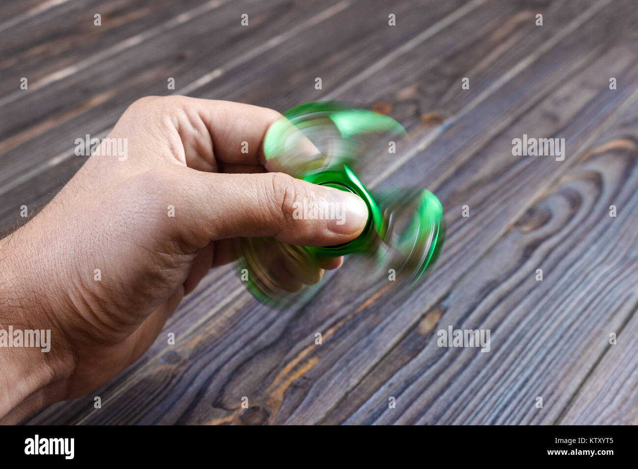 Hands holding popular fidget spinner toy. fidgeting spinner Stock Photo ...