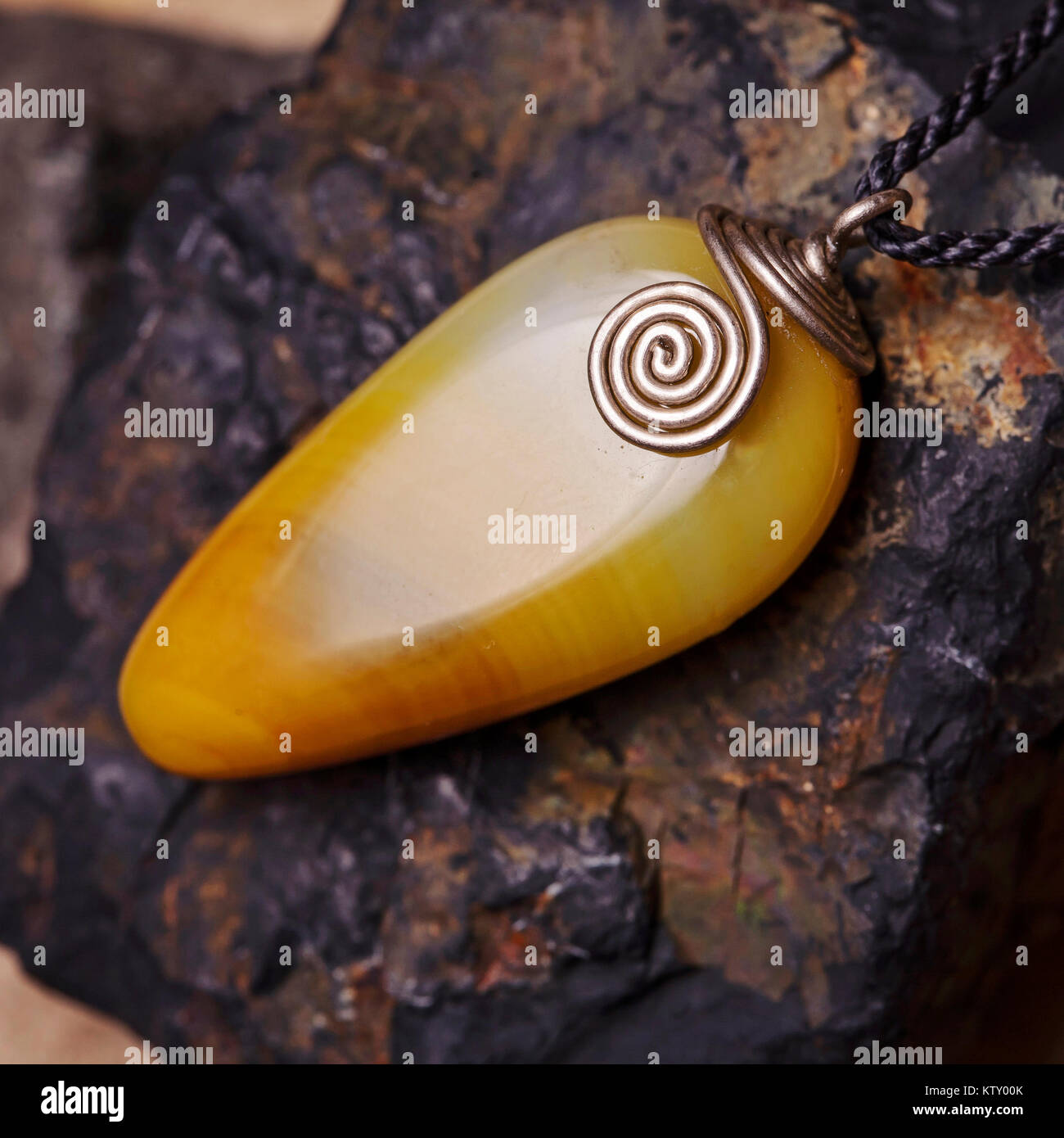 Stone bead necklace pendant on natural background Stock Photo - Alamy