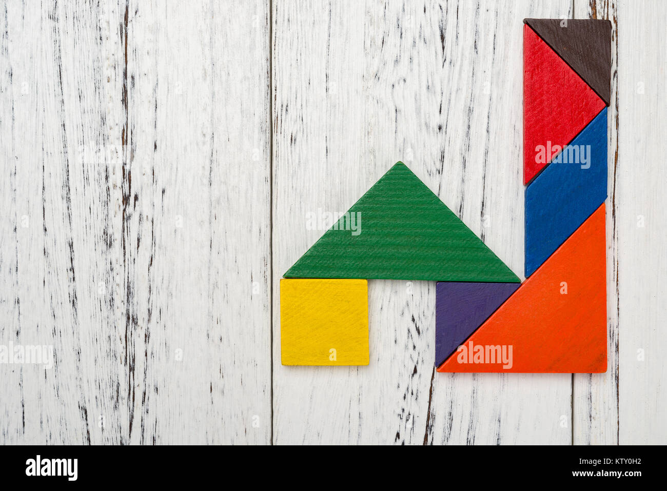 wooden tangram shaped like a factory with tall funnel with copy space ...