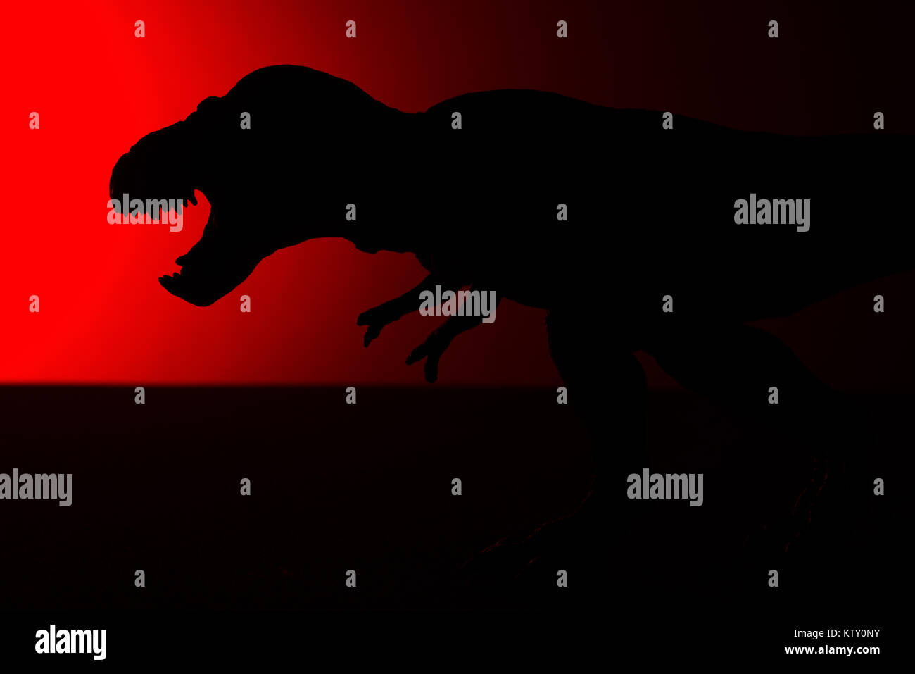 tyrannosaurus shadow with red light in dark Stock Photo - Alamy