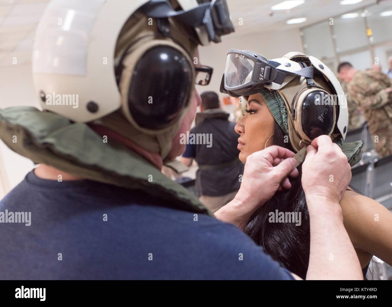 Wrestler Gail Kim puts on a helmet during the USO Holiday Tour at the ...