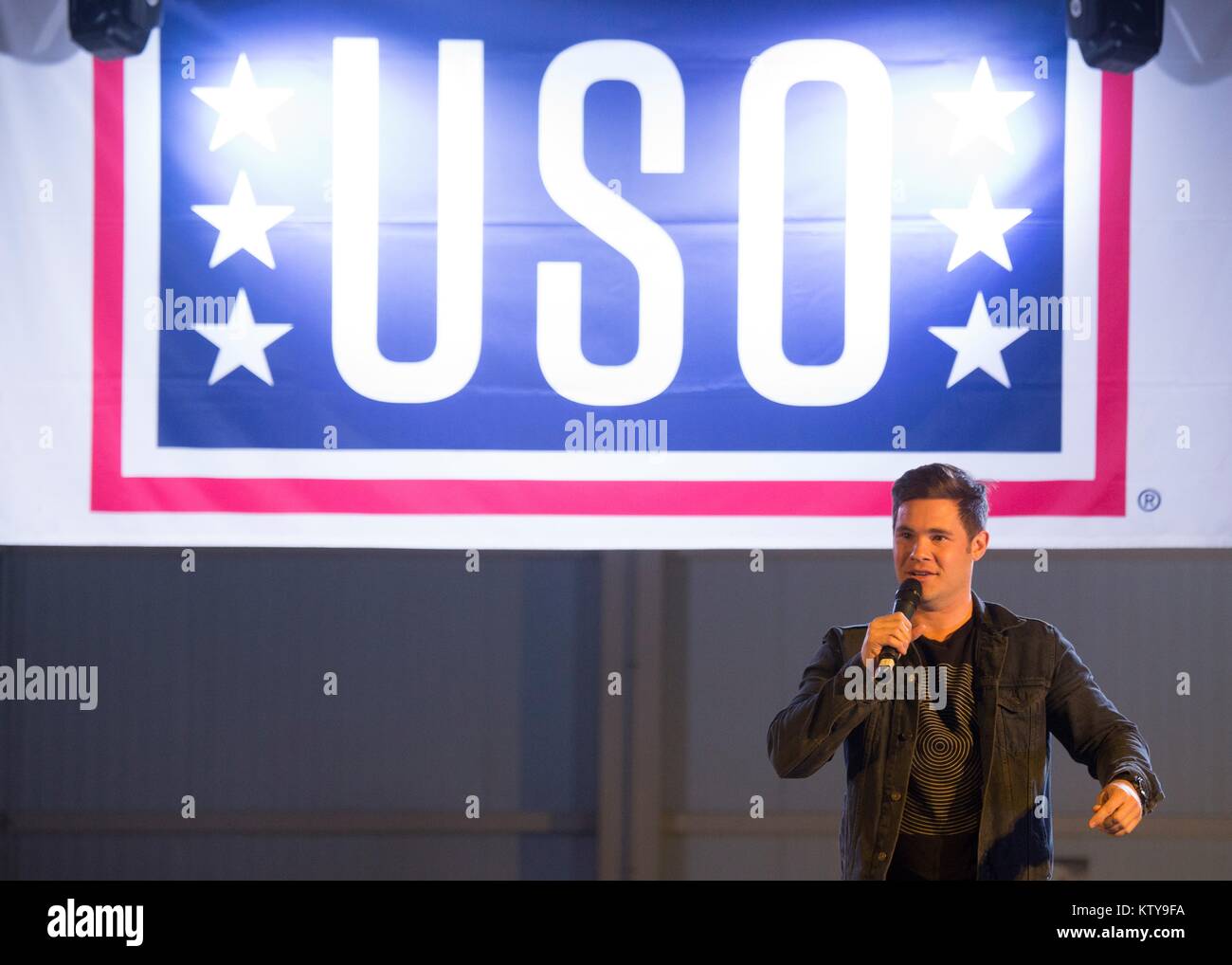 Actor Adam Devine performs for U.S. soldiers during the USO Holiday ...