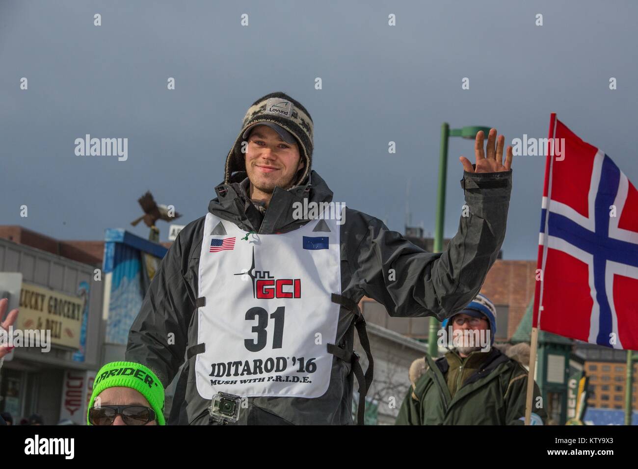 Sled dogs run through the snow during the start of the Iditarod Trail ...