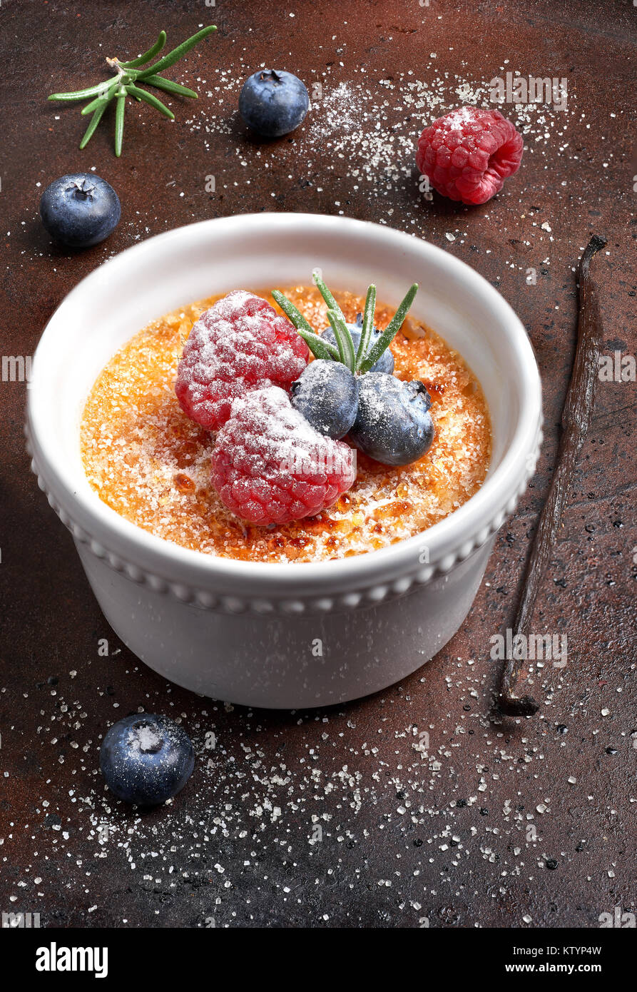 Creme brulee (cream brulee, burnt cream) with raspberry, blueberry and ...