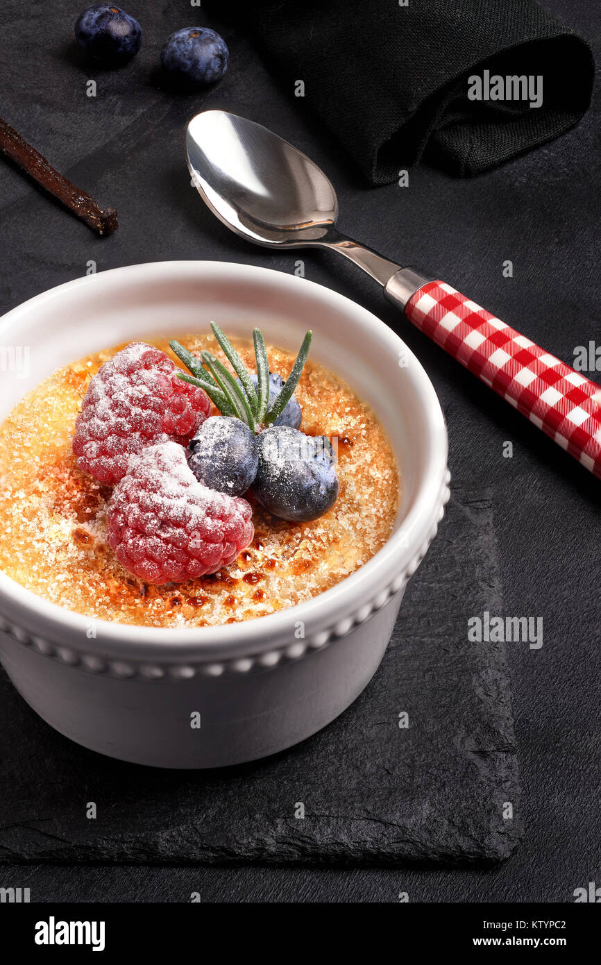 Creme brulee (cream brulee, burnt cream) with raspberry, blueberry and ...