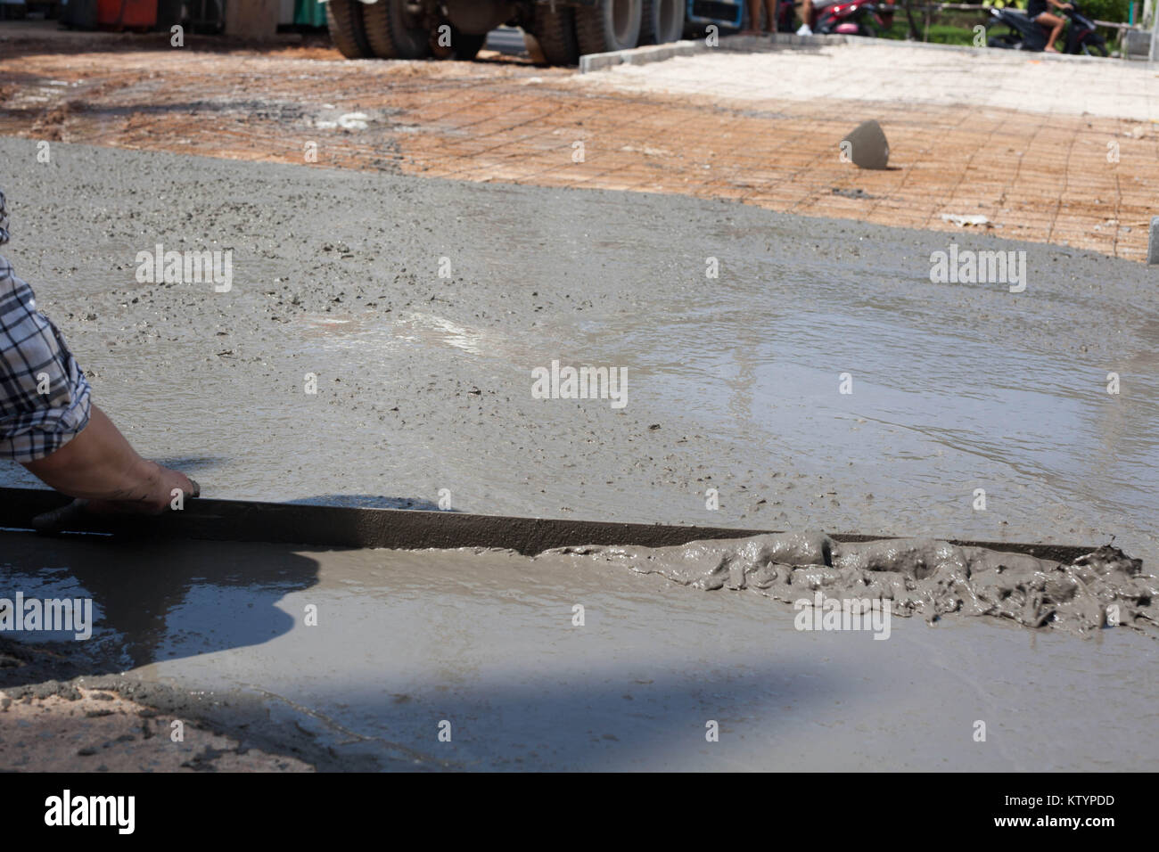 laborers made new construction of street and floor by cement concrete ...