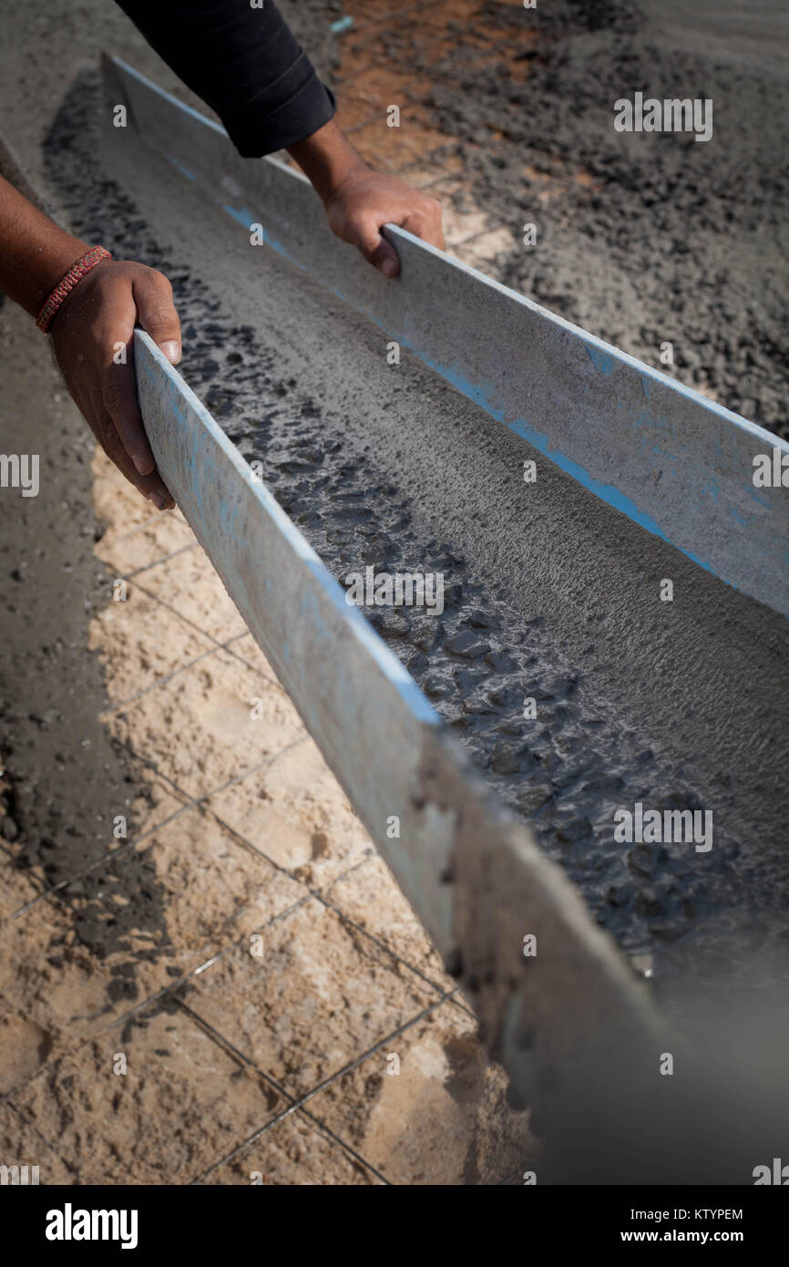 laborers made new construction of street and floor by cement concrete ...