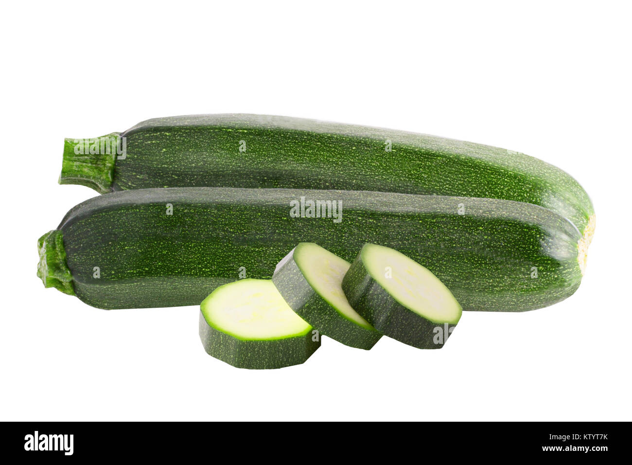 Isolated zucchini. Two whole zucchini and slices isolated on white ...