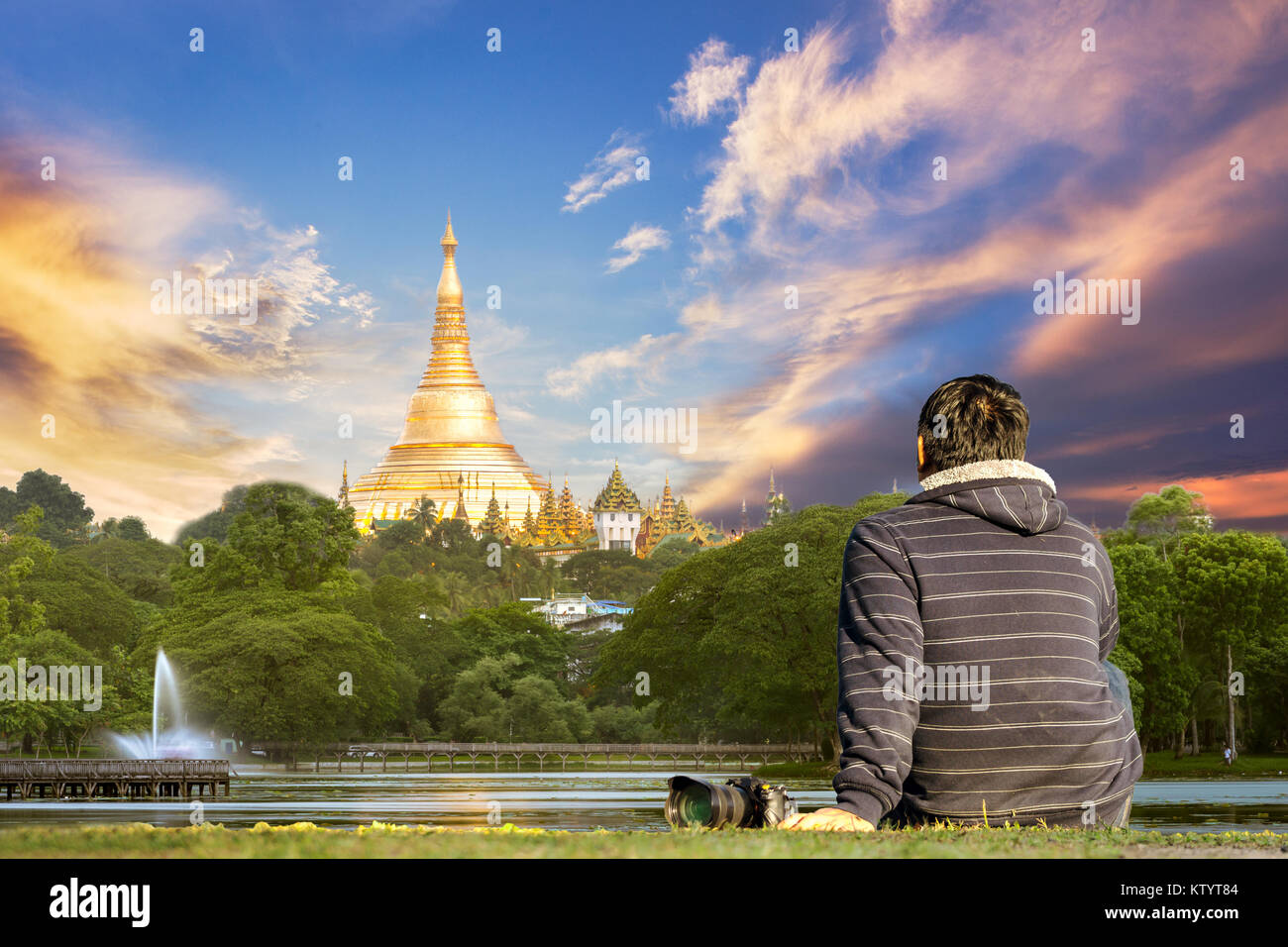 Photographer sit on grass and look for beautiful view Yangon, Myanmar ...