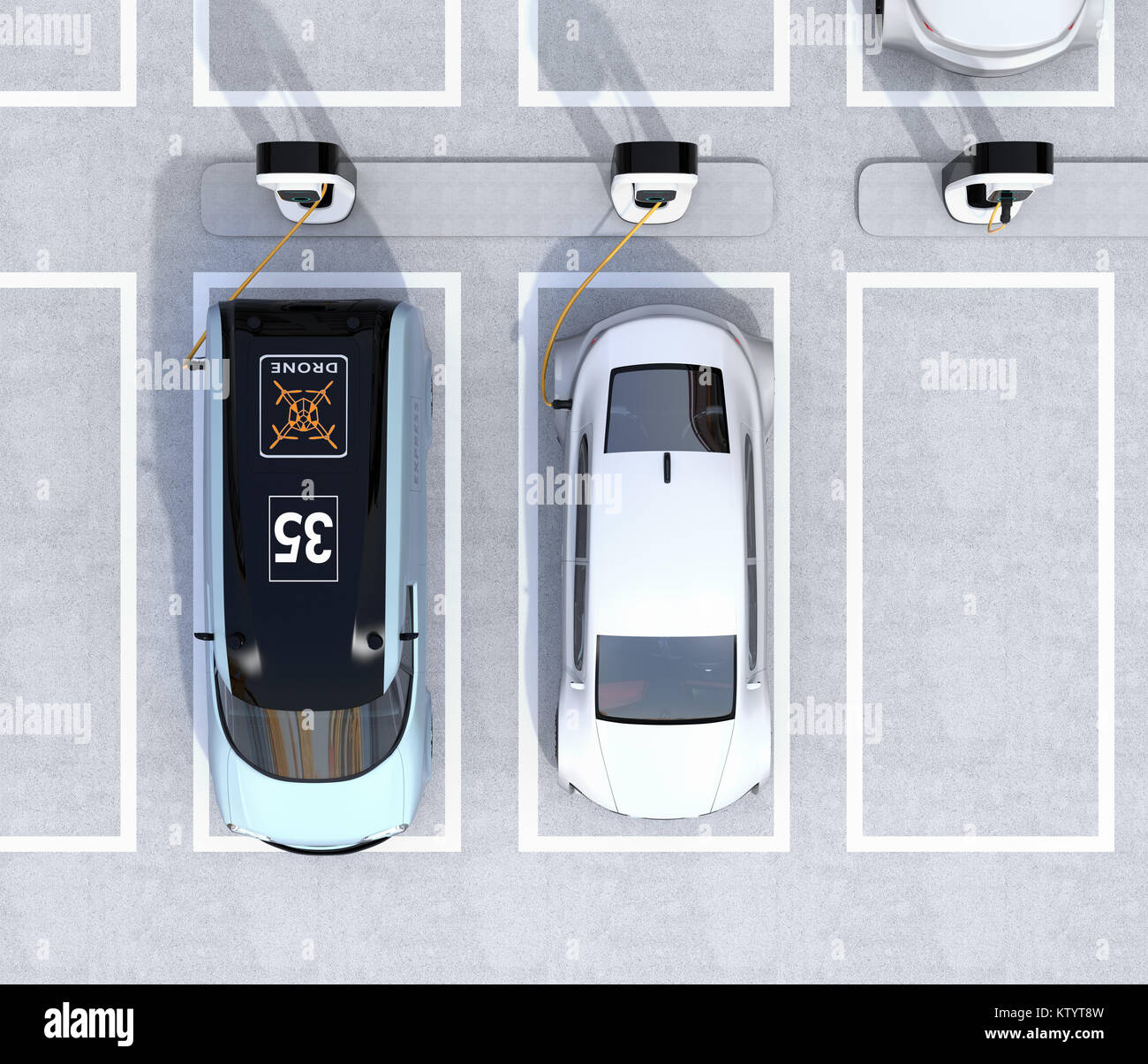 Top view of electric minivan and silver sedan charging at charging ...