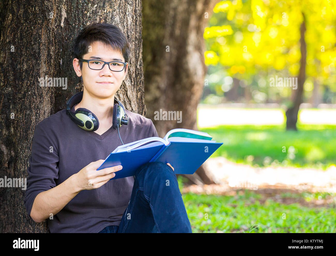 smart student read textbook and relax with listen the music by earphone ...