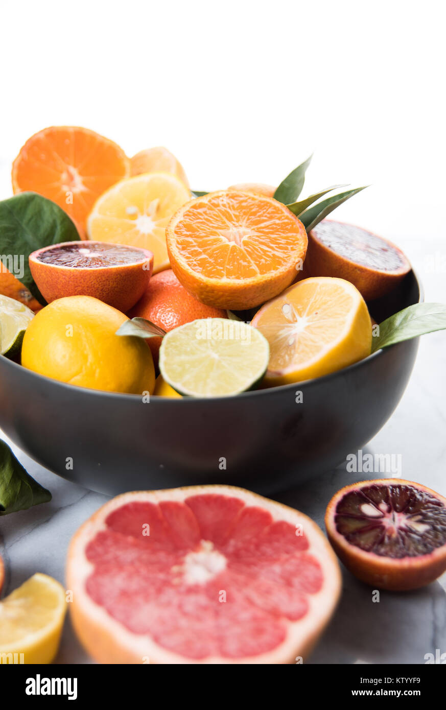 Fresh Blood Oranges, limes, and Lemons in Bowl on Marble Table Stock ...