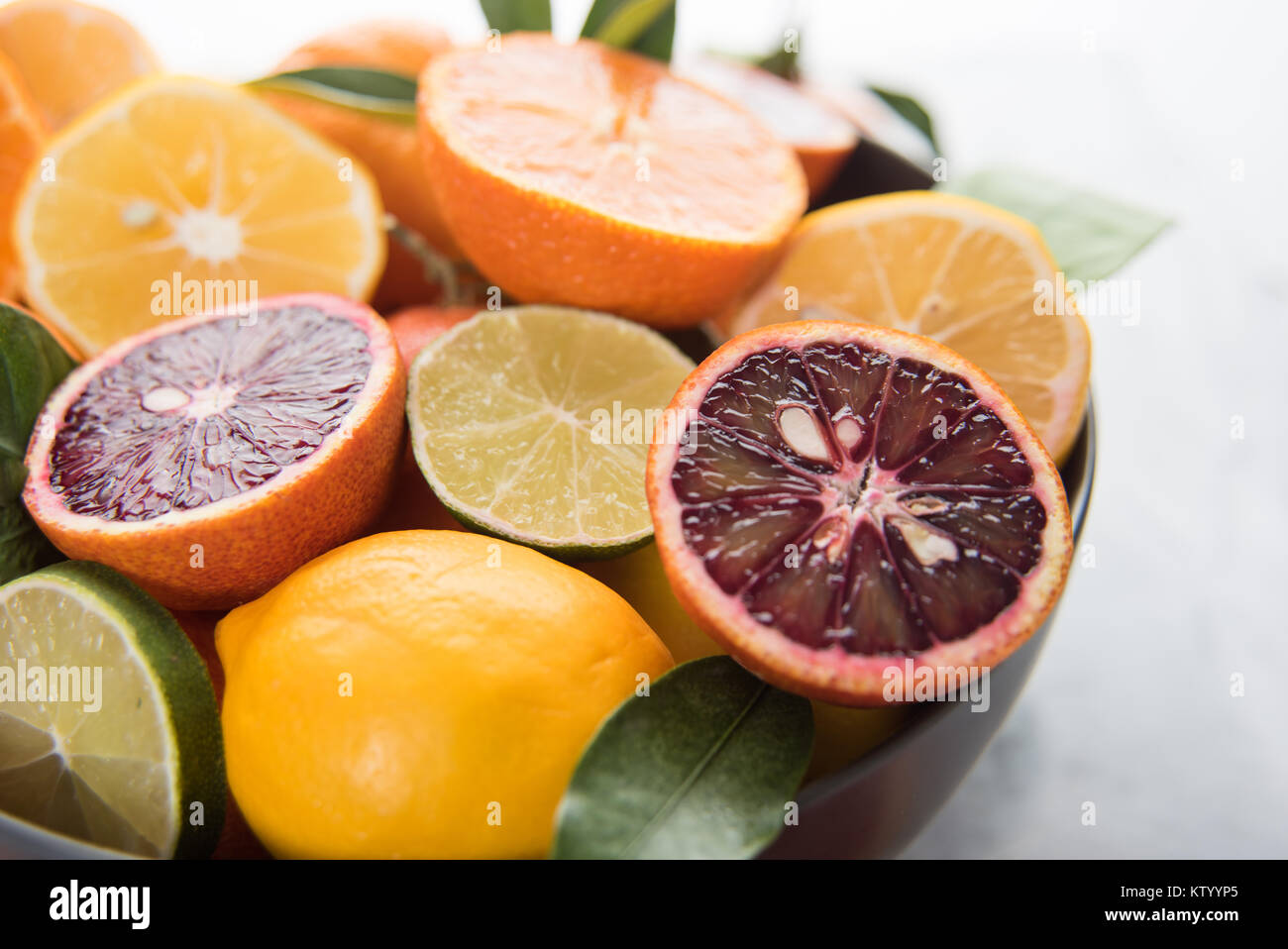 Fresh Blood Oranges, limes, and Lemons in Bowl on Marble Table Stock ...