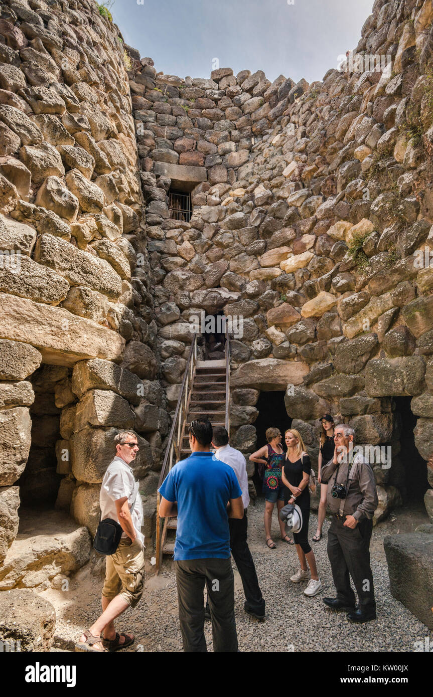 Guide and visitors at Nuraghe Su Nuraxi, 17th century BC, megalithic ...