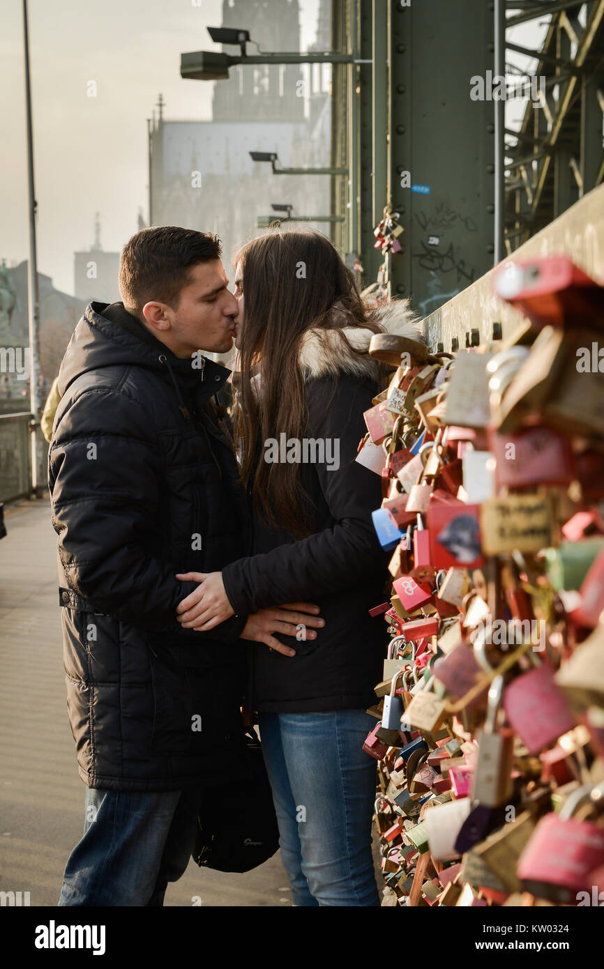 One couple kissing on a bridge in Cologne, full of love locks Stock ...