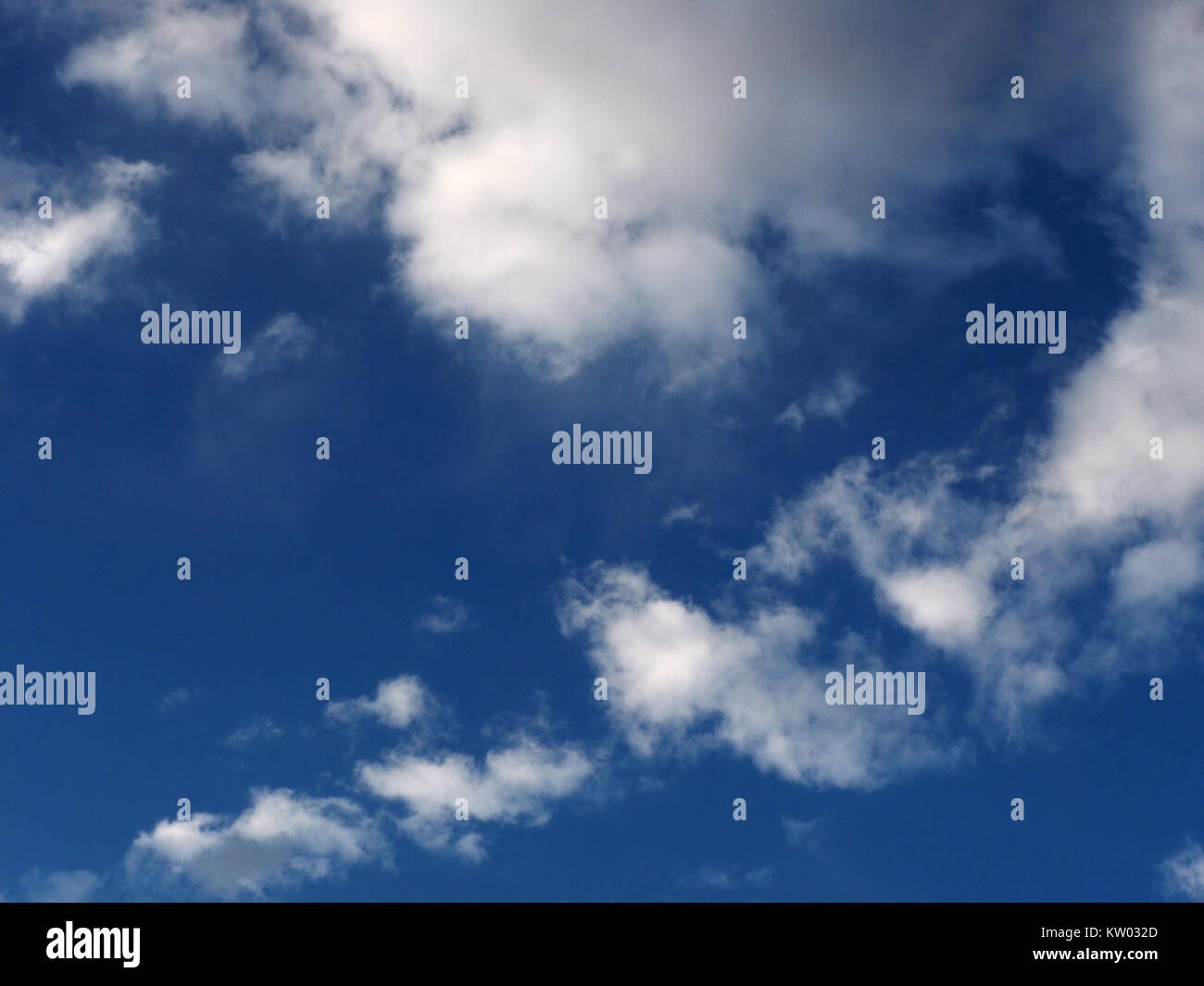 White diagonal cumulus clouds on a bright blue summer sky Stock Photo ...