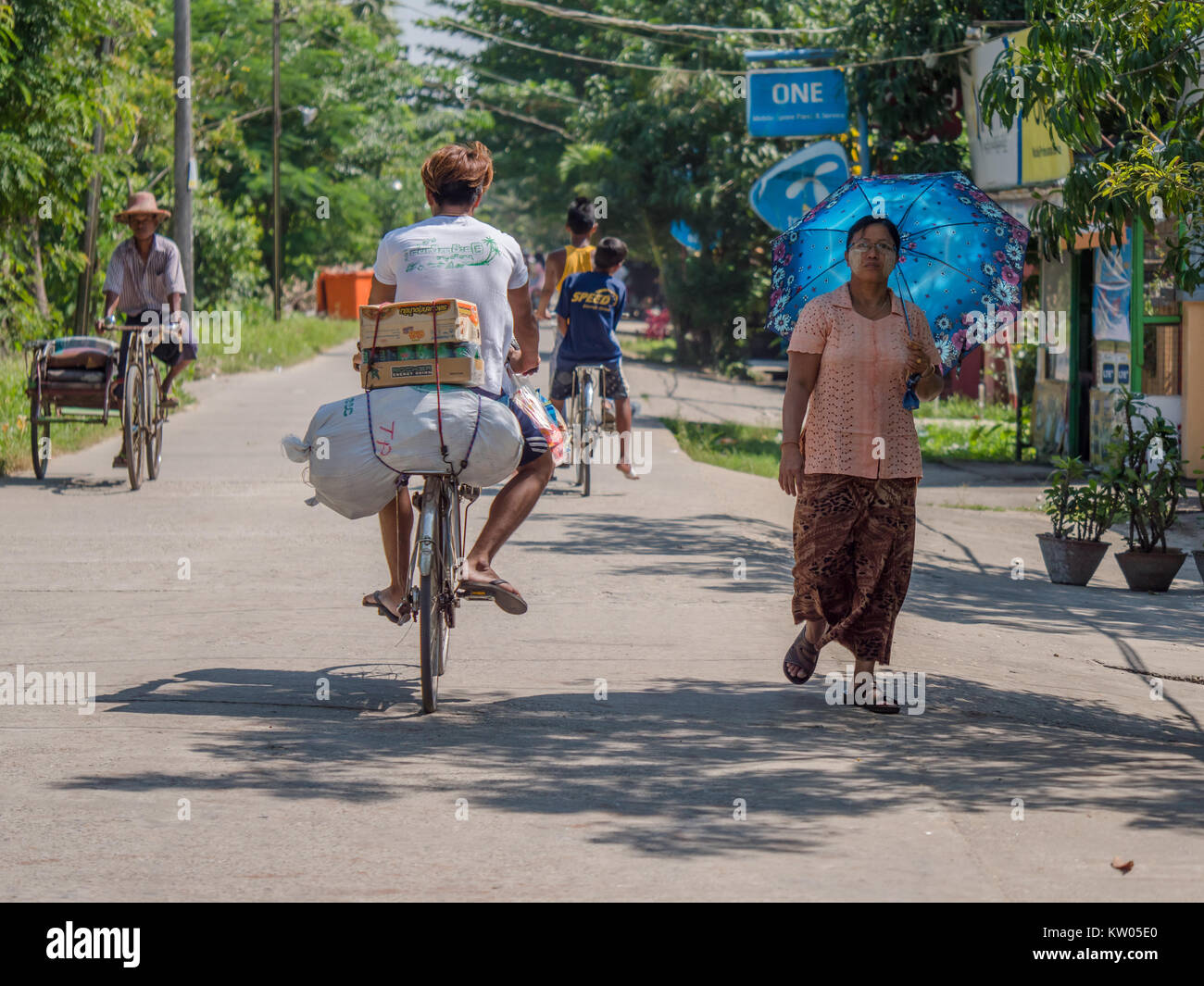 Road with local traffic in Dala Township, across the Yangon River from ...