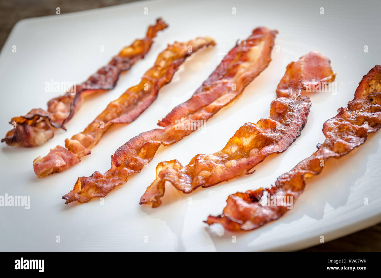 Fried bacon strips with chili pepper Stock Photo - Alamy