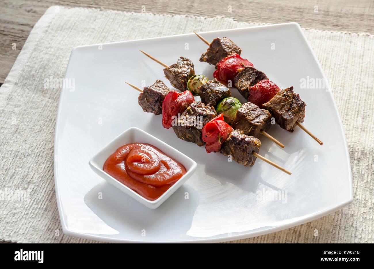 Grilled beef skewers with pepper and brussels Stock Photo - Alamy