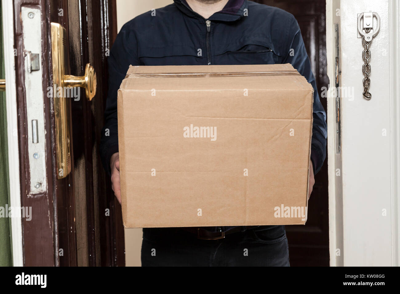 Postman brings a package Stock Photo - Alamy