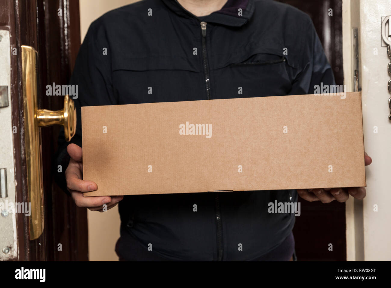 Postman brings a package Stock Photo - Alamy
