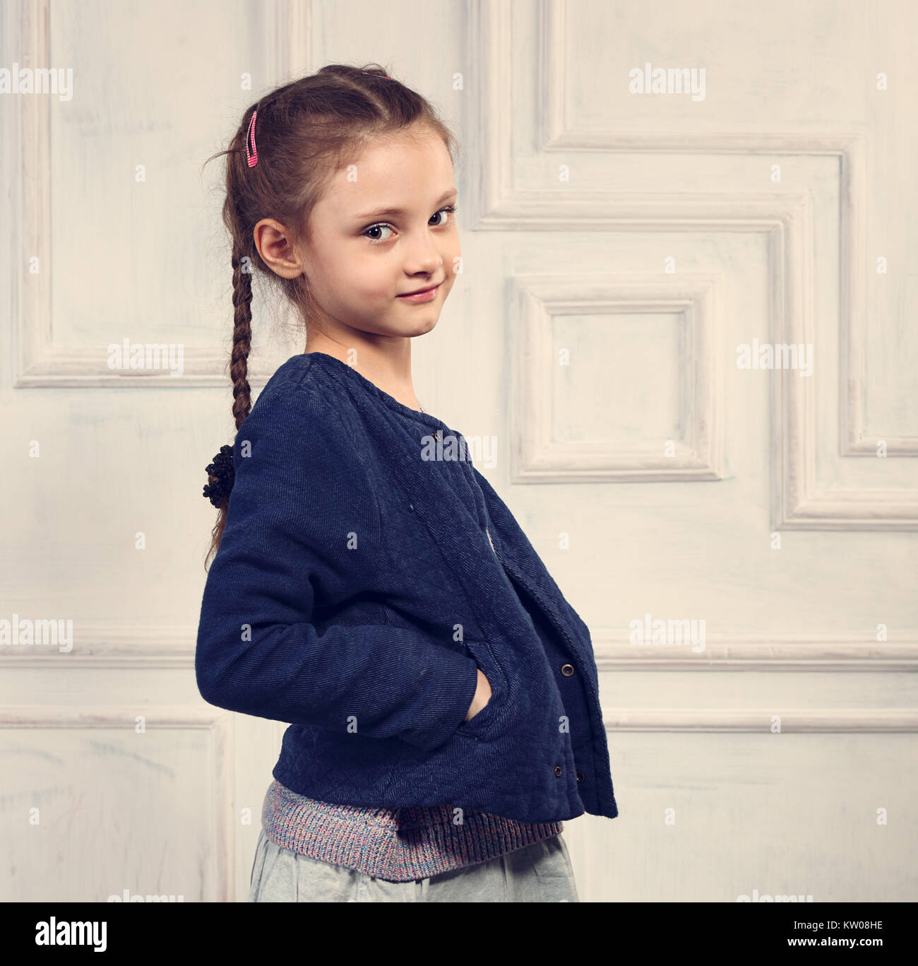 Happy fun smiling kid girl posing in fashion blue jeans, blouse and ...