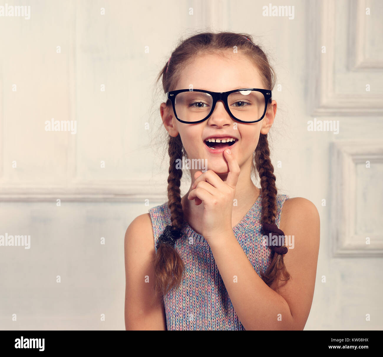 Excited positive thinking kid girl in fashion glasses with emotional ...