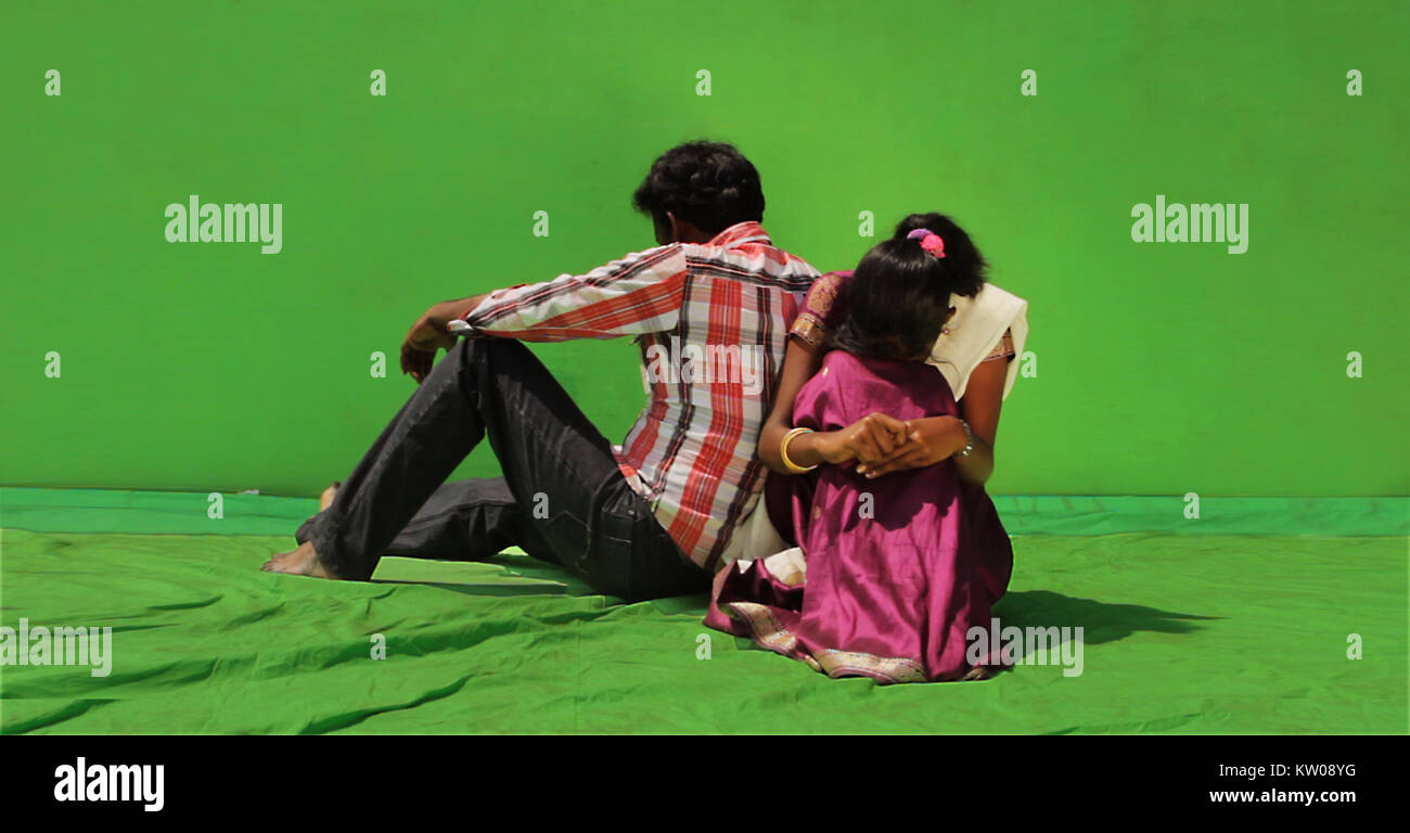 young boy with girl crying in green screen Stock Photo - Alamy